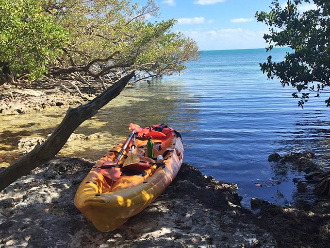 Your chariot awaits! A colorful kayak rests at the shore, ready for the next island-hopping adventure.