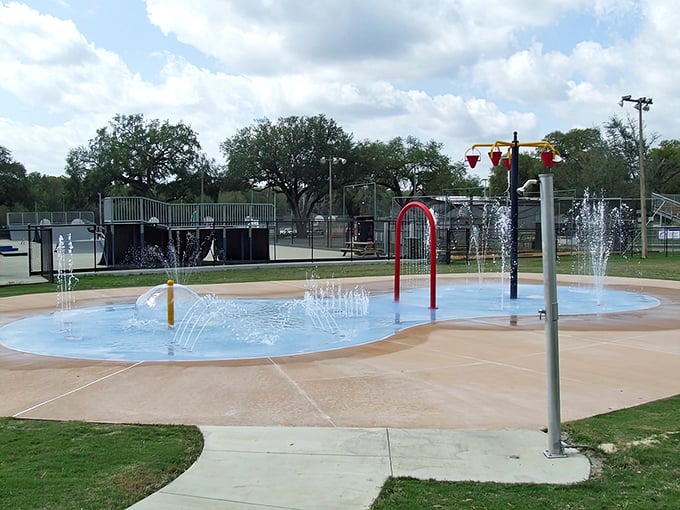 Children navigate through a forest of water jets, each unpredictable spray creating squeals of delight in this aquatic obstacle course.