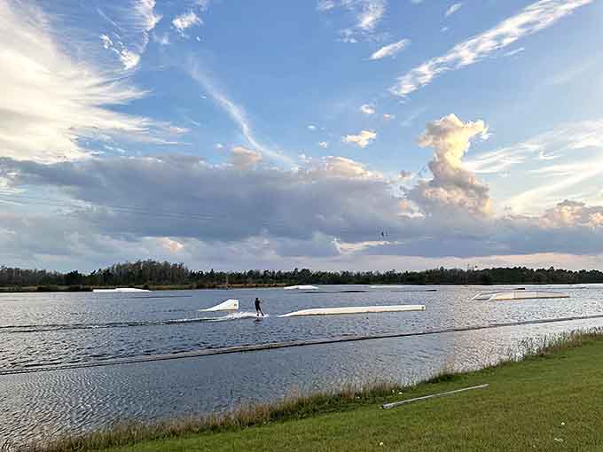 Gliding across the wakeboarding lake with surprising grace – until the inevitable spectacular wipeout that everyone pretends they didn't see.