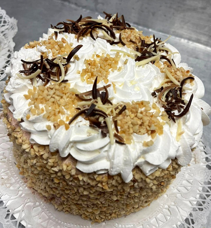 Layers of moist cake crowned with swirls of frosting and toasted coconut capture Miami's tropical glamour in dessert form.