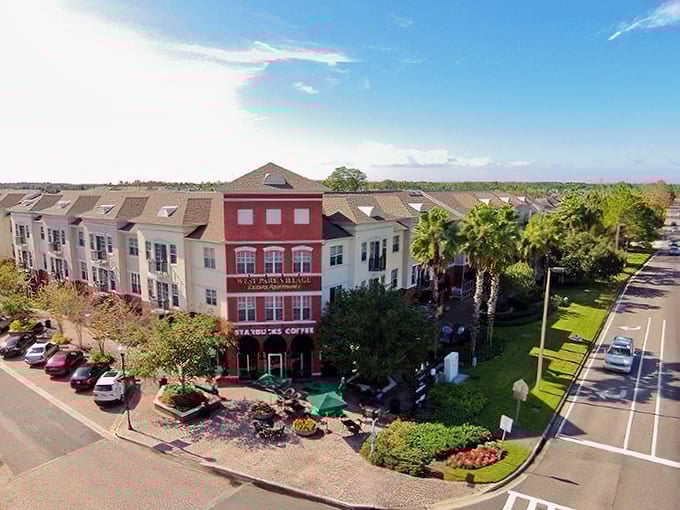 Mixed-use buildings with shops and cafes create walkable town centers where community life thrives beyond just residential streets and cul-de-sacs.