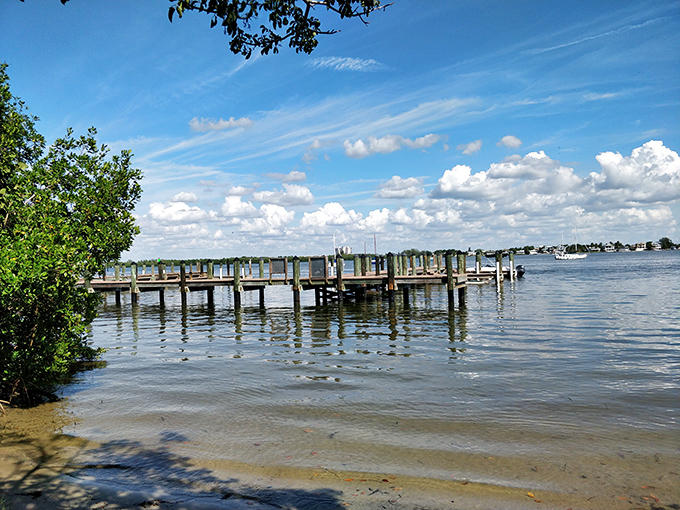 The meeting of bay and Gulf waters creates a boater's paradise, with wooden docks extending into calm waters perfect for fishing.