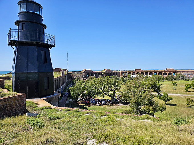 Garden Key Light standing within the impressive hexagonal walls of Fort Jefferson, surrounded by lush greenery in this remote island fortress.