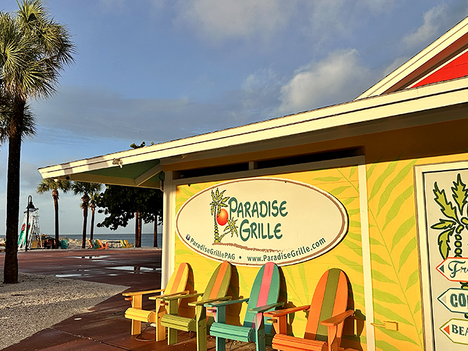 The casual outdoor seating at Paradise Grille lets diners enjoy Gulf views and colorful Adirondack chairs just steps from the water.