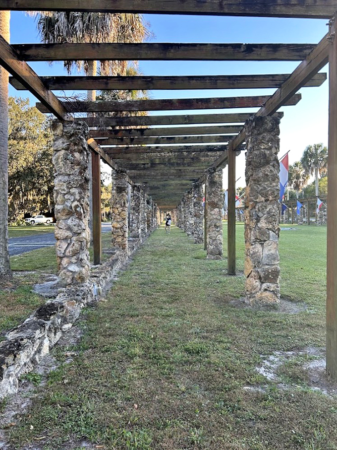Historic stone columns form a shaded walkway at Ravine Gardens State Park, blending human craftsmanship with natural Florida beauty.