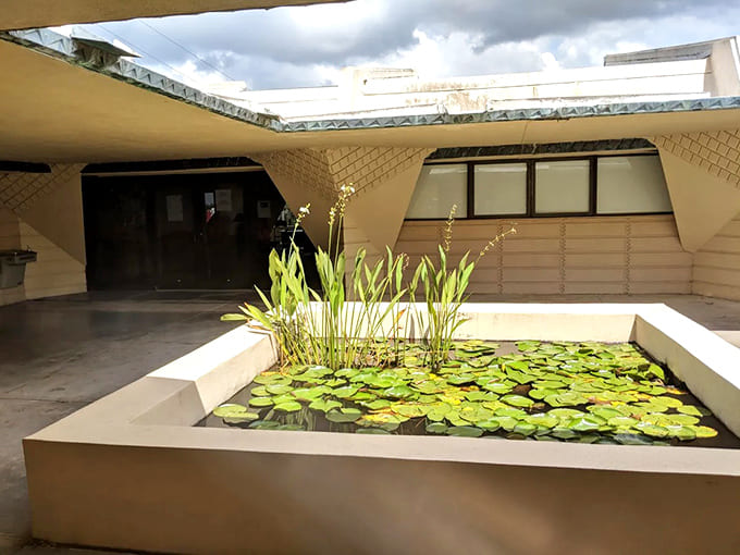 The reflecting pond at Ordway Building mirrors Wright's vision, where water and architecture engage in peaceful conversation all day.