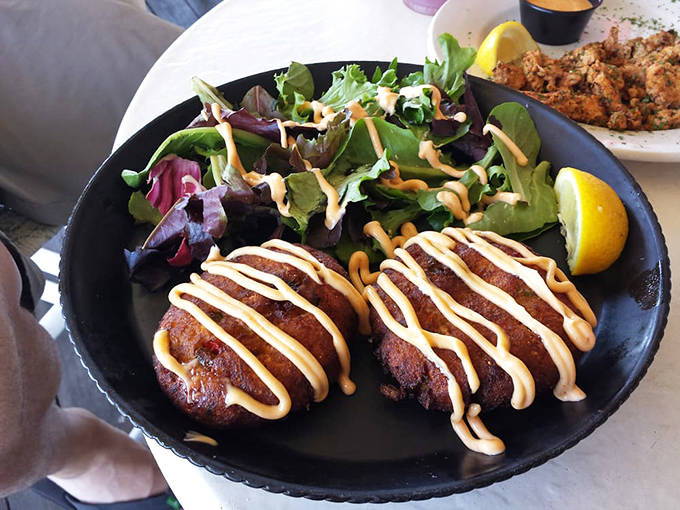 Crab cakes with actual crab (imagine that!) drizzled with sauce that complements rather than drowns &ndash; a rare and beautiful thing.