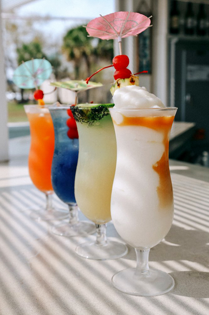 Tropical cocktails that look like Florida sunsets in a glass, complete with those little umbrellas that somehow make everything taste better.