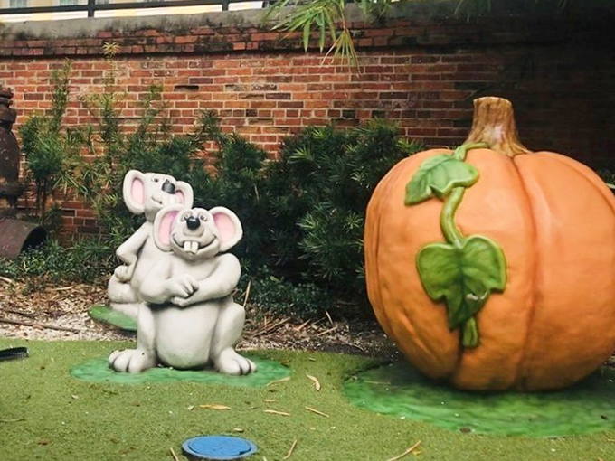 These koala-like mice figures huddle together beside an oversized pumpkin, creating an unexpected fairytale vignette in Tampa.