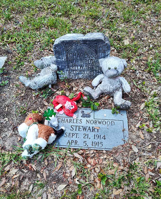 Even the smallest graves receive loving attention, with toys and flowers showing that some losses never stop hurting, no matter how much time passes.
