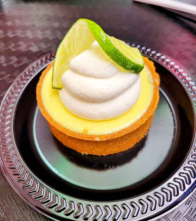 Key lime pie with a swirl of cream and a citrus garnish&mdash;Florida meets Greece in the sweetest possible way.