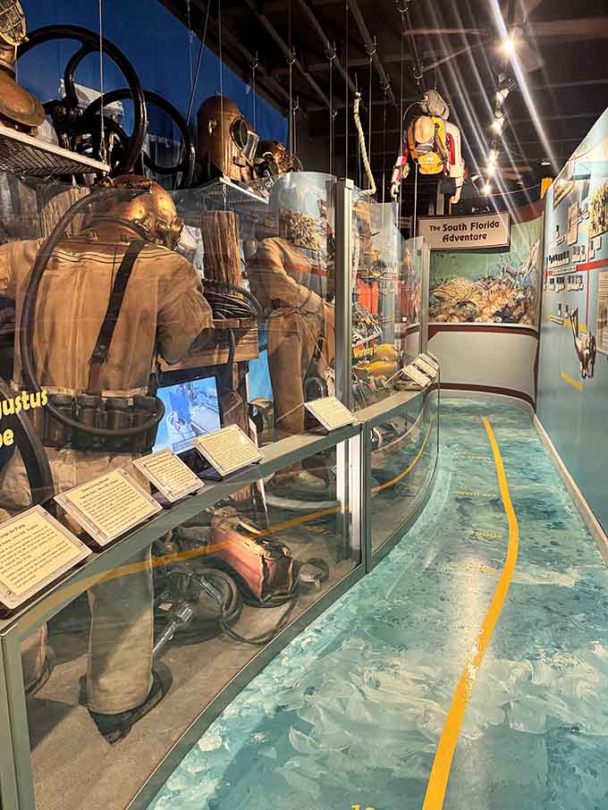 Vintage diving gear hangs suspended like underwater astronauts, each suit representing someone's brave decision to explore the ocean's depths decades ago.