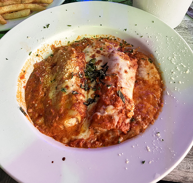 Bubbling cheese blankets this hearty pasta dish, proving Shuckers excels beyond just seafood classics.