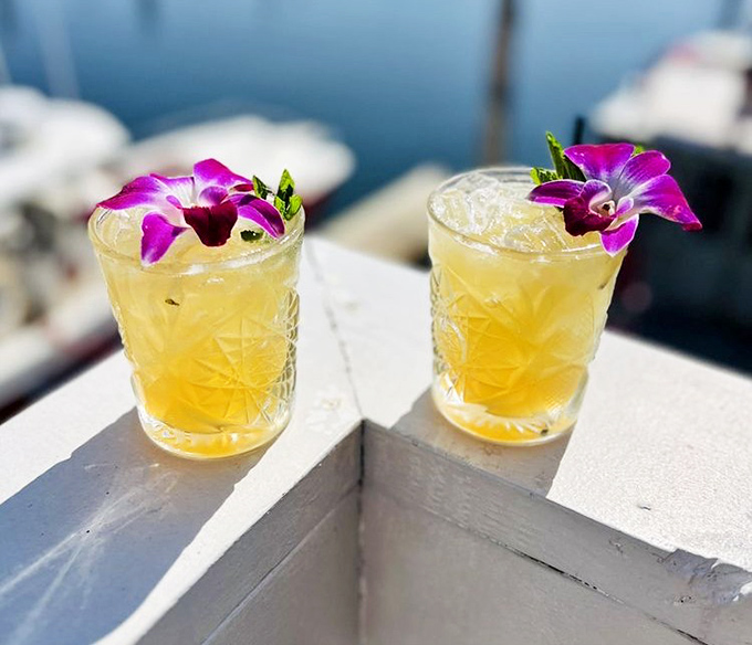 Two golden mai tais adorned with orchids&mdash;drinks that scream "vacation" even if you're just playing hooky from a Tuesday afternoon meeting.