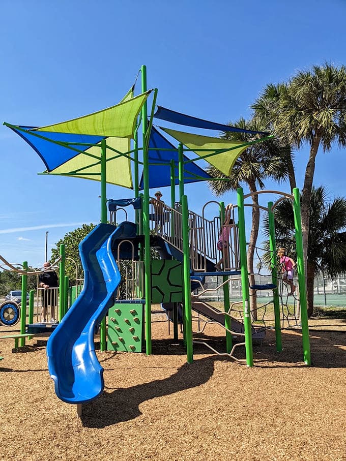 The playground's colorful canopy promises hours of entertainment while parents relax within eyeshot of the action.