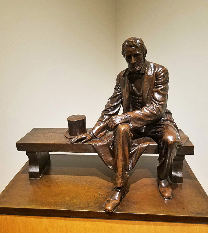 Lincoln sits in contemplation, probably thinking, "Four score and seven selfies ago, people actually looked at art."