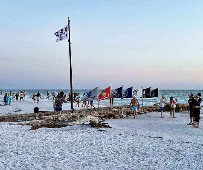Sunset gatherings become impromptu celebrations as nature paints the sky and beachgoers pause to applaud day's grand finale.