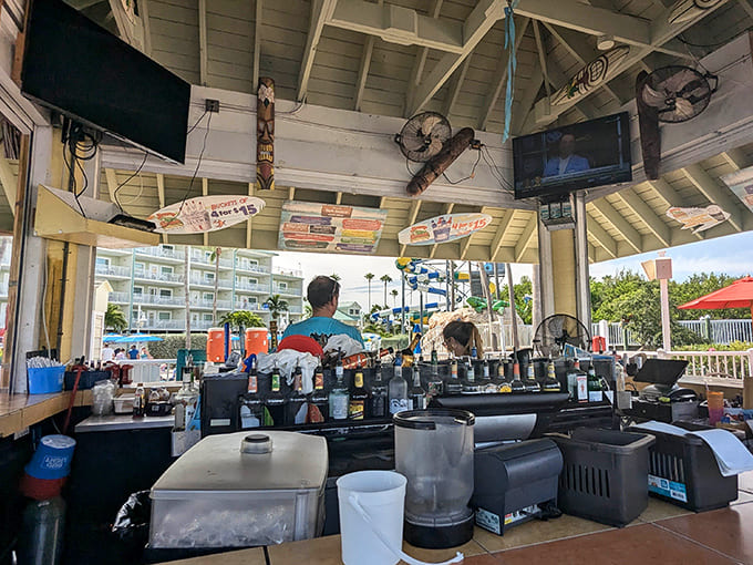 The poolside bar stands ready to fuel your adventures with cold drinks and hot food, because heroes need sustenance between slide runs.