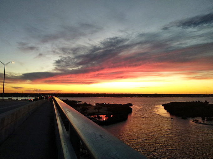 Nature's own light show outperforms any man-made spectacle as day surrenders to night over the Halifax River – no special effects required.