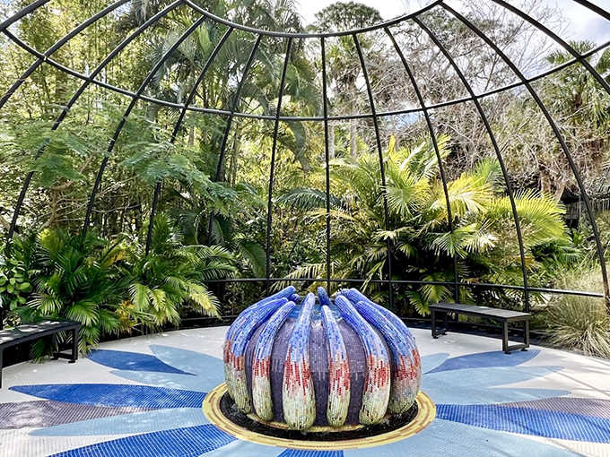 This mesmerizing blue glass sculpture rises from the water like a frozen splash, catching sunlight and imagination in equal measure.