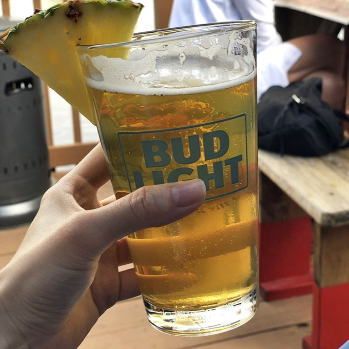 A cold beer with pineapple garnish &ndash; the unofficial state beverage of Florida relaxation and the perfect companion to fresh seafood.