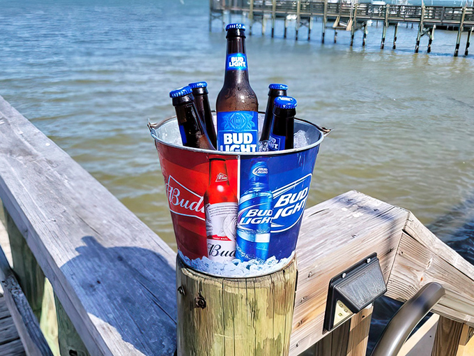 A frosty bucket of beer stands ready for duty, the perfect cooling counterpoint to the warm, rich flavors of garlic-infused seafood.