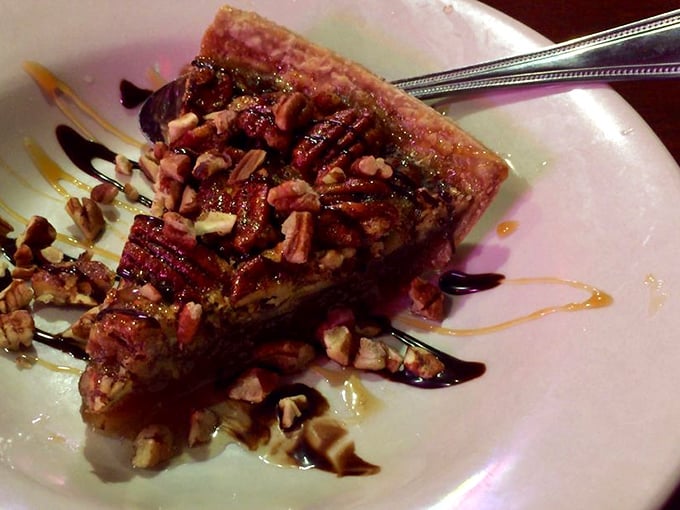 Warm pecan pie, its gooey filling studded with crunchy nuts and drizzled with chocolate sauce &ndash; Southern indulgence that demands you slow down and savor.