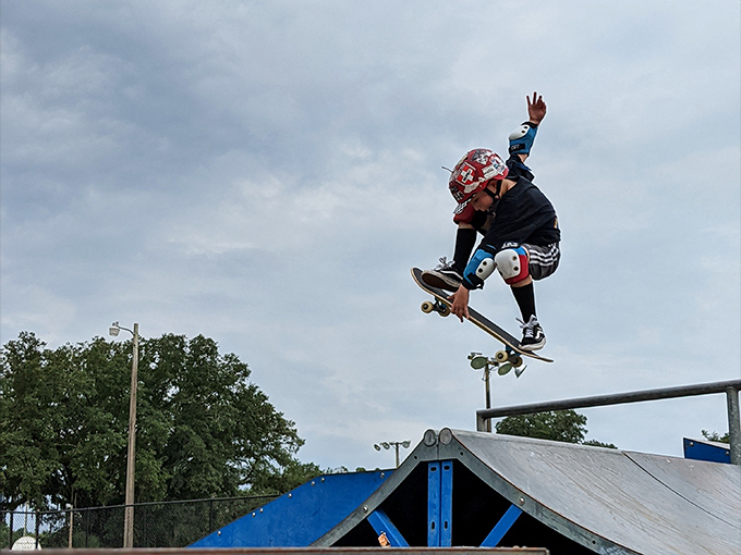 A young skateboarder catches serious air off the ramp, demonstrating that courage comes in all sizes at Alachua's dual-purpose park.