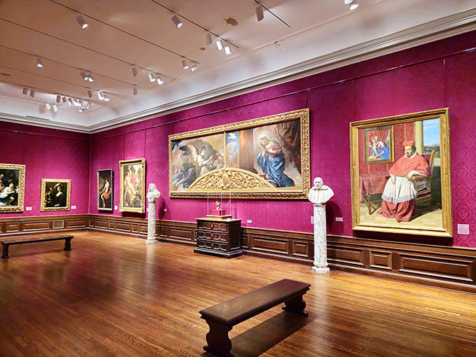 Rich crimson walls provide the perfect backdrop for Renaissance masterpieces, creating a jewel box of artistic treasures.