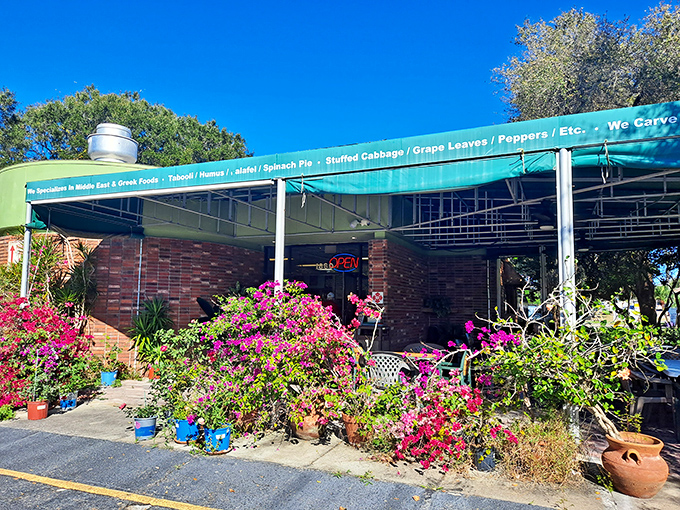 Flowering plants surround Bread & Butter Gourmet Deli, creating a colorful welcome. This Tarpon Springs gem blends Greek and Middle Eastern flavors beautifully.