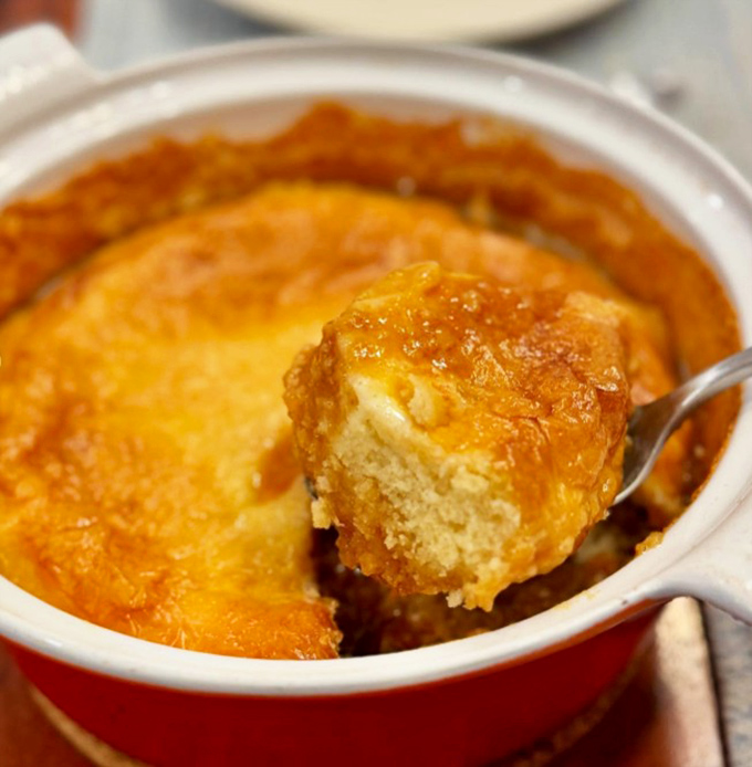 That golden color comes from slow cooking and plenty of sharp cheddar – the perfect canvas for showcasing local seafood or sausage.