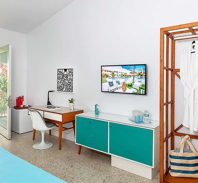 A perfect marriage of work and relaxation where turquoise storage meets warm wood desk &ndash; productivity with a side of style.