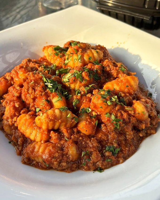Gnocchi Bolognese that doesn't just sit on the plate &ndash; it beckons, each pillowy dumpling swimming in Sunday-gravy perfection.