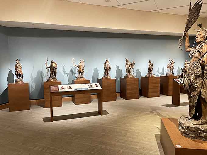A collection of bronze figures stands ready to tell their stories, each one a window into frontier life.