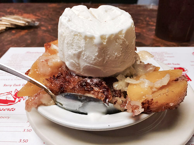 Peach cobbler topped with ice cream melting into warm fruit&mdash;a sweet symphony that plays perfectly after a barbecue crescendo.