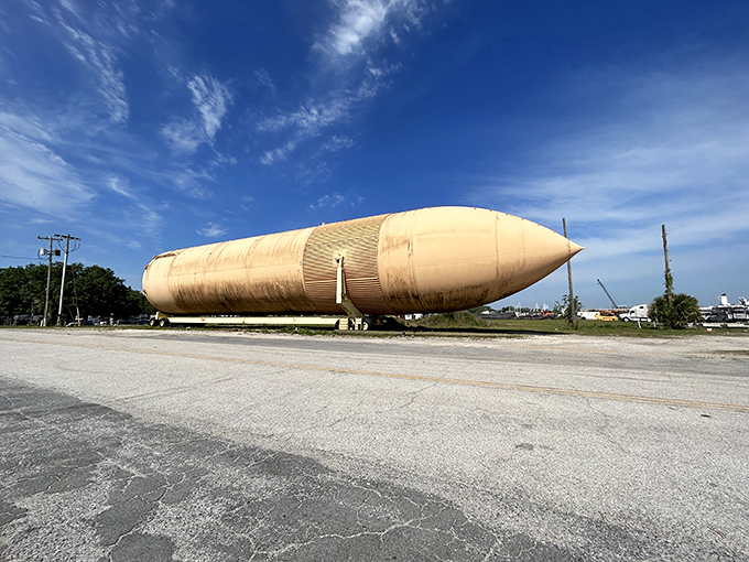 Against the brilliant blue Florida sky, the tank's weathered exterior glows with an almost ethereal quality. Space history basking in subtropical splendor.