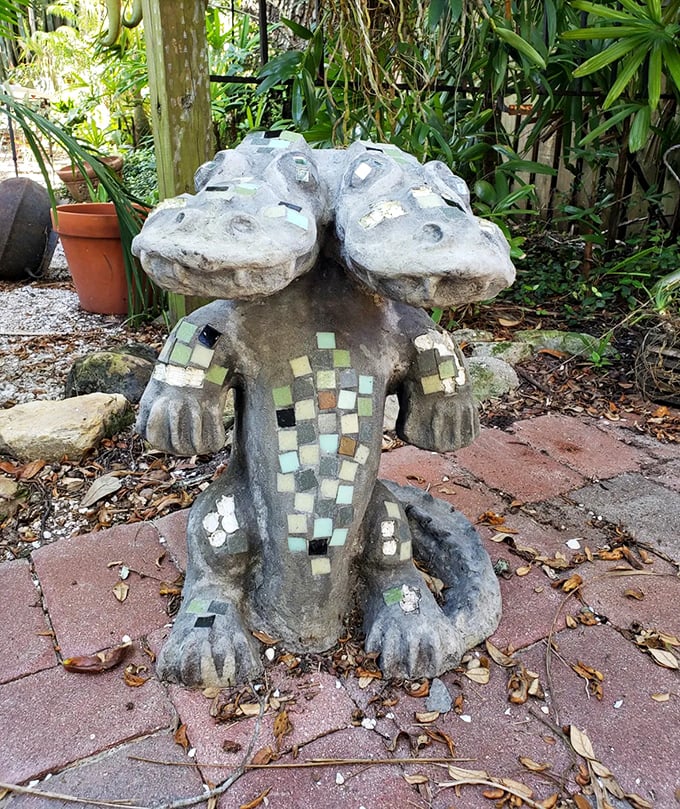 Even garden statues get the two-headed treatment in Seminole Heights &ndash; this weathered version stands guard among tropical foliage.