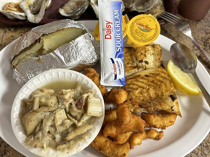 A perfectly fried fish fillet with sides that know their supporting role but still manage to steal scenes. That baked potato is practically begging for butter.