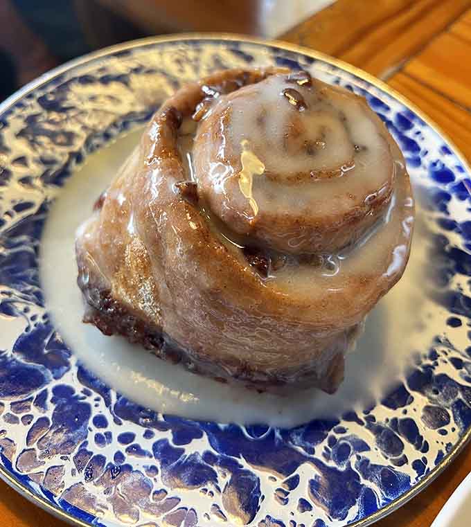 A cinnamon roll so generously sized and glazed, it could probably be seen from space, or at least from across the dining room.