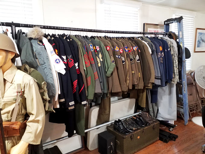 Rows of military uniforms and gear showcase the evolution of American military dress, proving that camouflage patterns have come a long way since grandpa's service days.