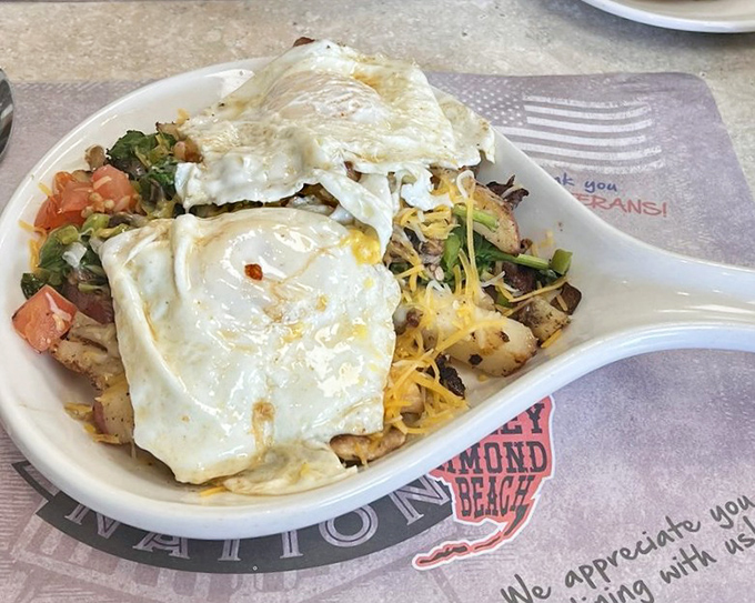 This breakfast skillet isn't messing around &ndash; a sizzling foundation of potatoes topped with eggs and enough toppings to require a nap afterward.