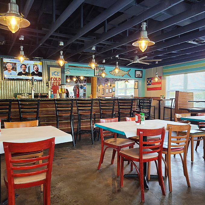 The casual dining room buzzes with conversation as guests enjoy fresh seafood under the warm glow of pendant lights.