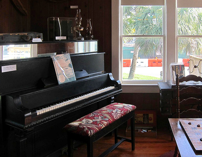 The vintage piano sits patiently in the corner, keys yellowed with age, waiting for phantom fingers to play melodies from beach parties past.