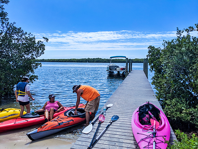 Adventure headquarters: Visitors prepare for aquatic exploration at the wooden dock, where rainbow-colored kayaks promise different perspectives of paradise.
