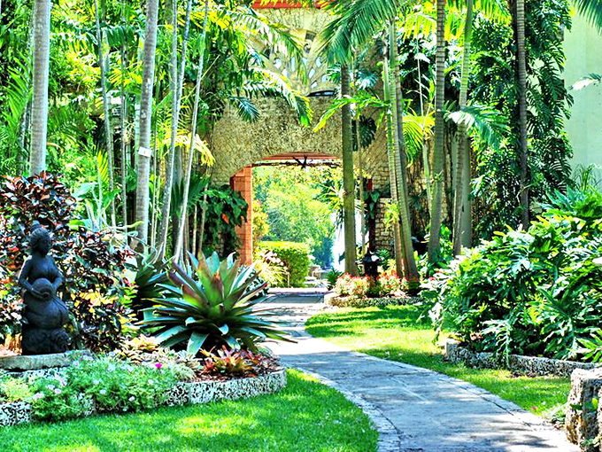 The Kampong's garden pathways lead through botanical treasures collected from around the world, creating a living museum of tropical splendor.