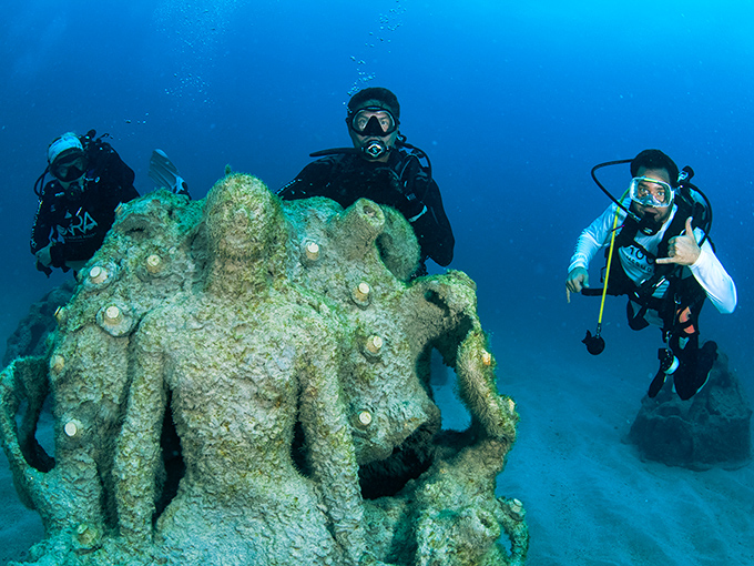Divers explore the hauntingly beautiful mermaid sculptures that form the backbone of this living underwater art gallery.