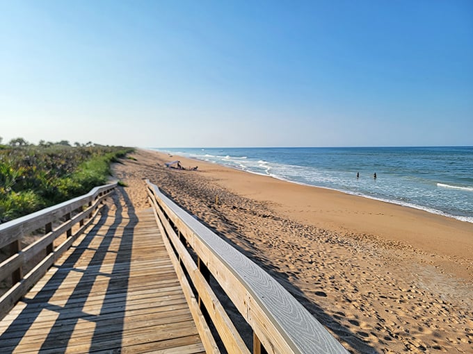 Castle Windy Trail welcomes adventurers with a wooden boardwalk stretching toward pristine shores, where footprints tell stories of fellow explorers.