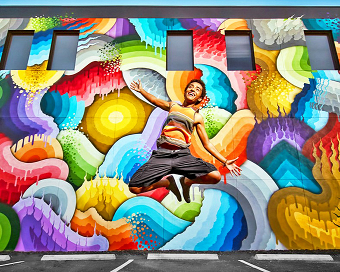 A kaleidoscope of colors erupts across this Central Arts District wall – like Mother Nature and a box of crayons had a wild night out.