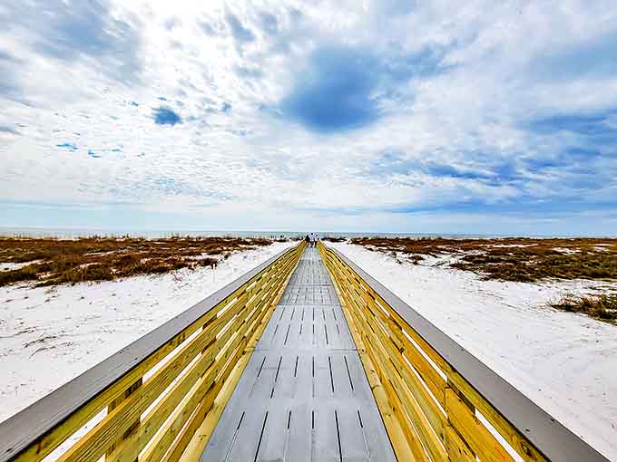 A wooden boardwalk stretches toward infinity, inviting adventurers to leave the ordinary behind and discover Crooked Island's pristine shores.