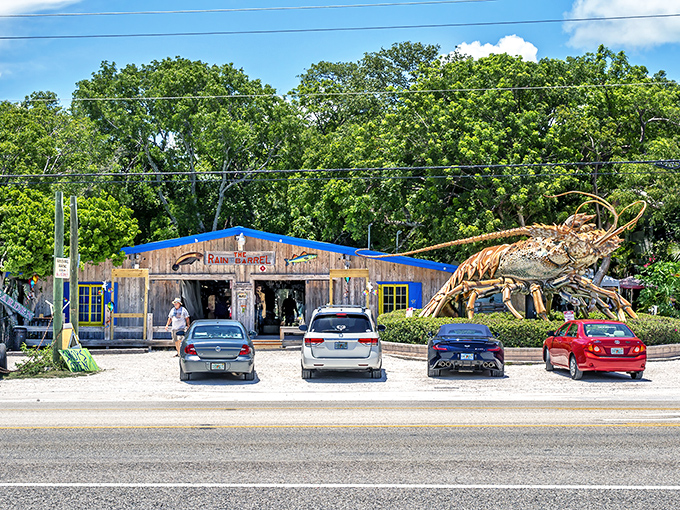 Welcome to roadside paradise! Rain Barrel Village greets visitors with rustic charm and that giant lobster sculpture that's become an iconic Keys photo op.